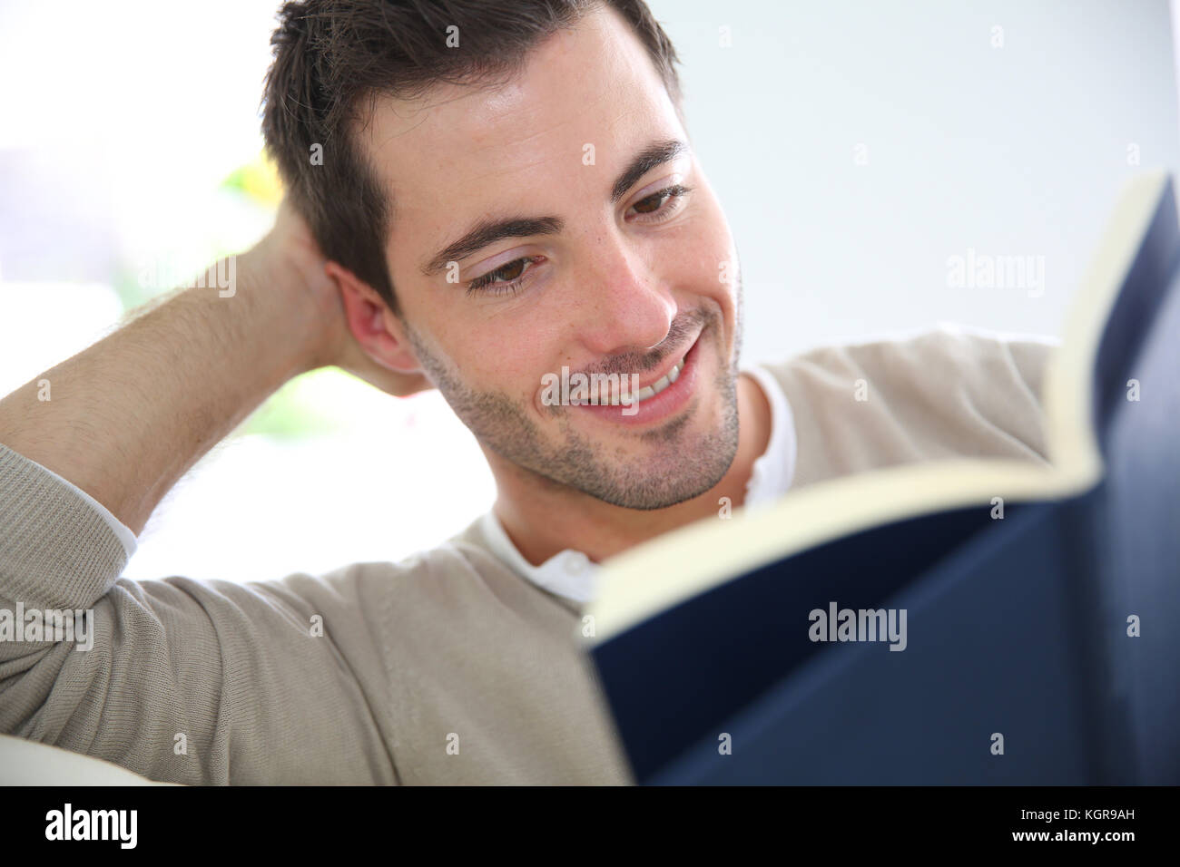 Handsome unshaven man reading hi-res stock photography and images - Alamy
