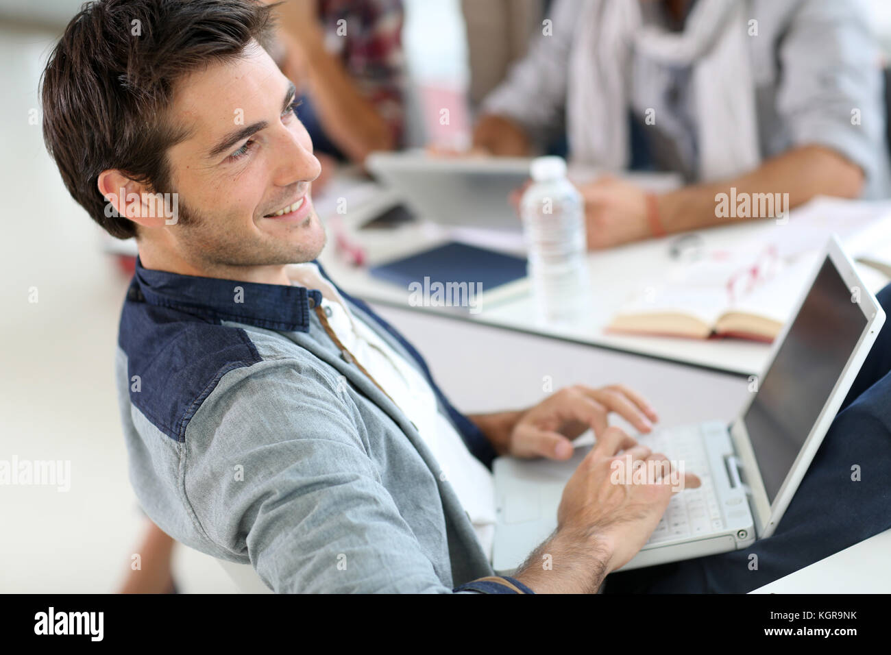 Student in campus relaxing with laptop Stock Photo - Alamy