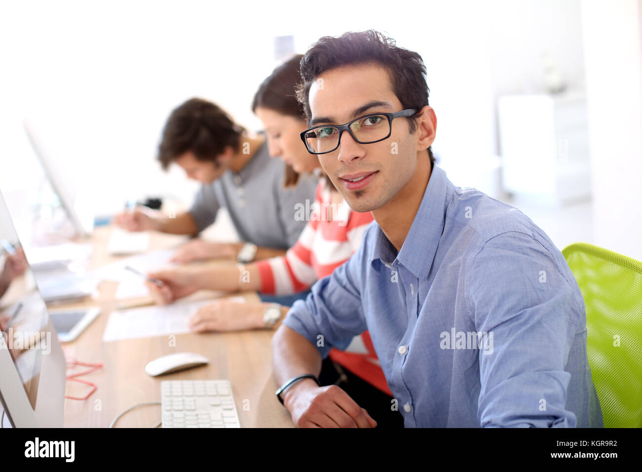 Young man in business apprenticeship Stock Photo - Alamy