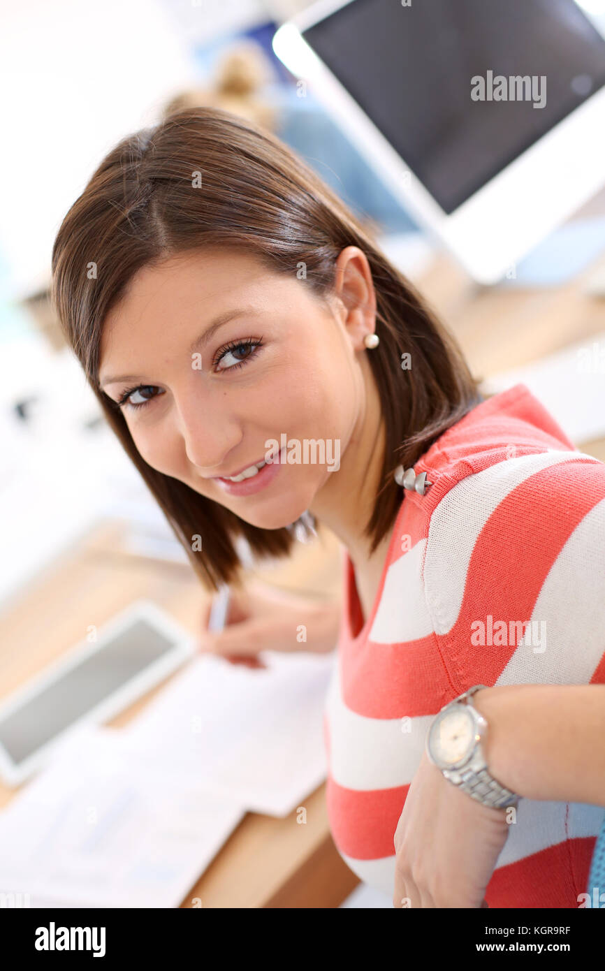 Smiling young woman in training class Stock Photo - Alamy