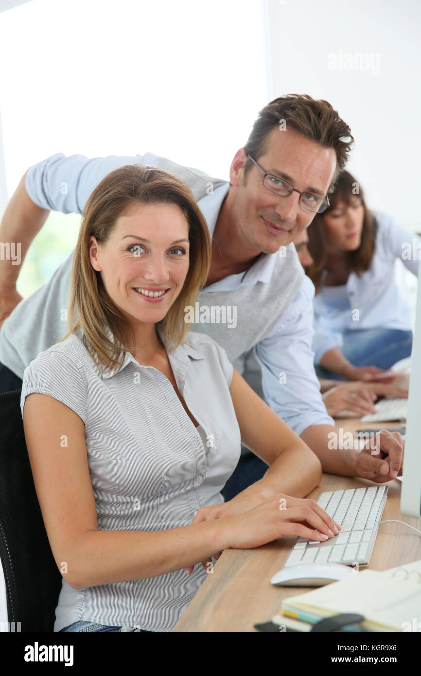 Middle-aged business people working on deskop computer Stock Photo - Alamy
