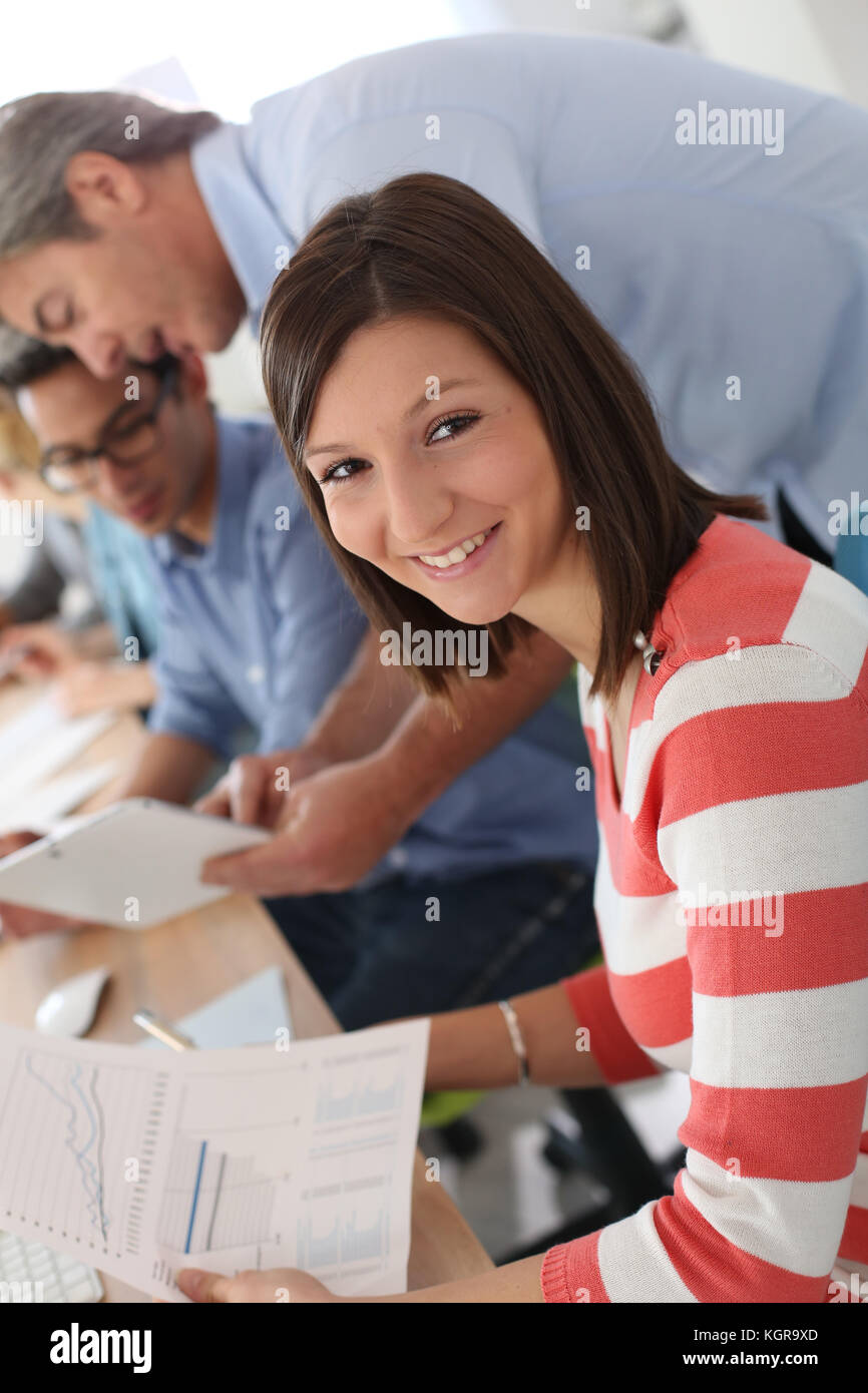 Smiling young woman in training class Stock Photo - Alamy
