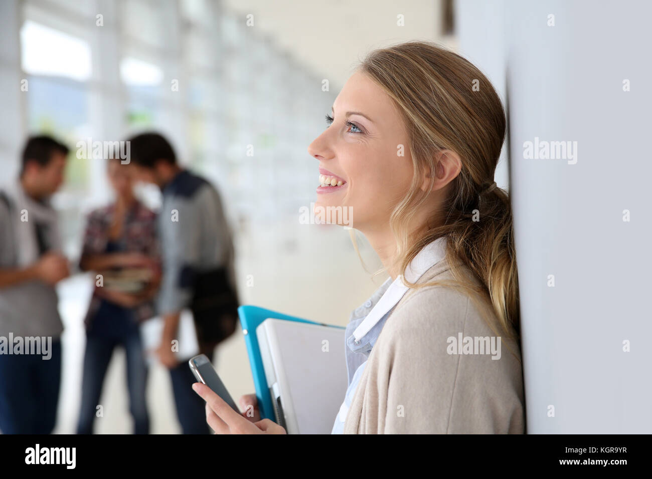 Young woman in school campus using smartphone Stock Photo - Alamy