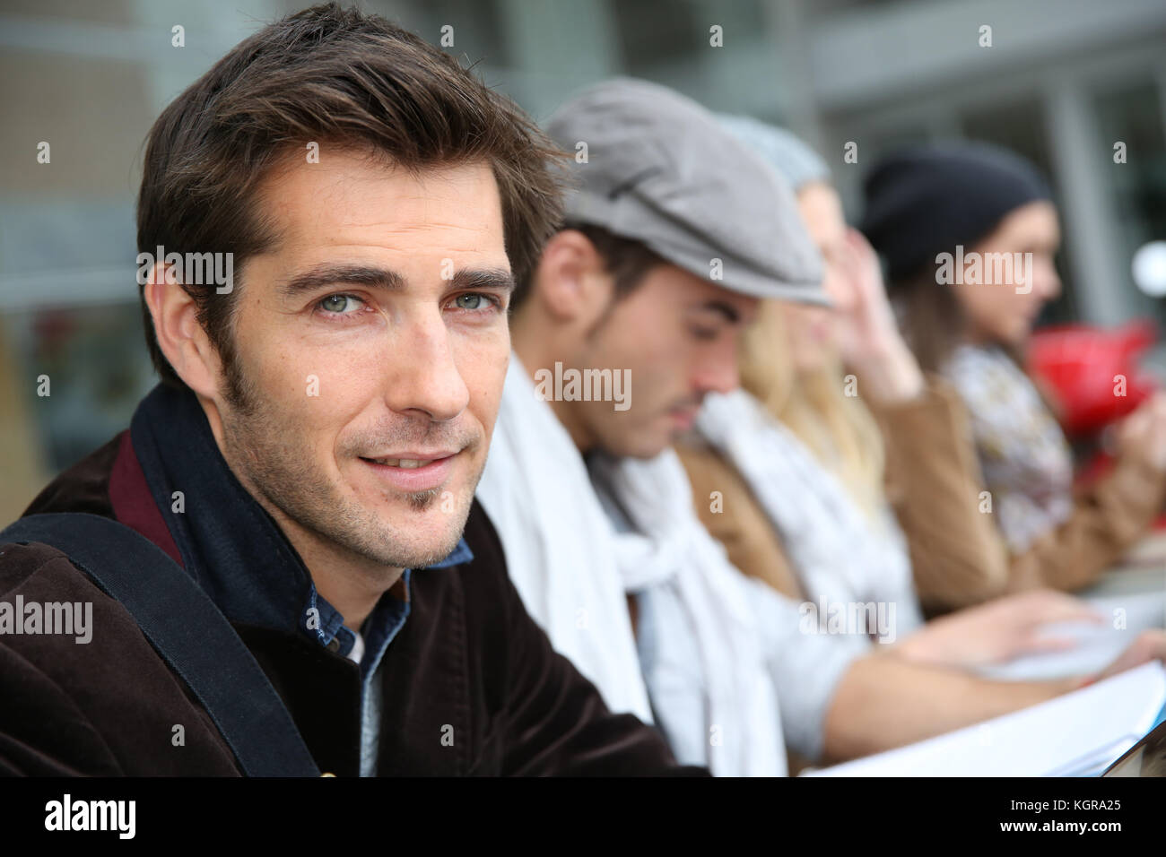 Student guy standing outside school building Stock Photo - Alamy