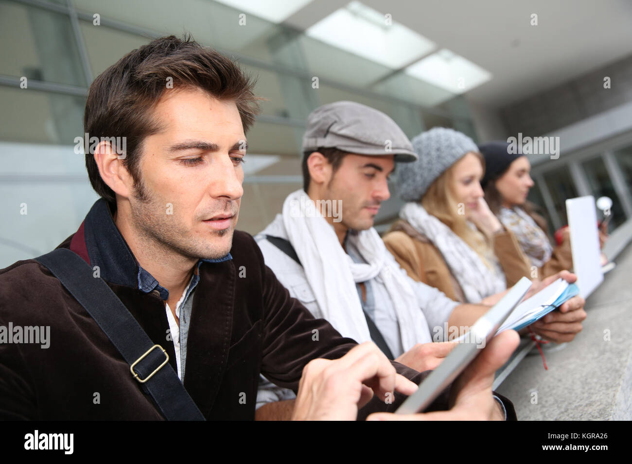Student guy standing outside school building Stock Photo - Alamy