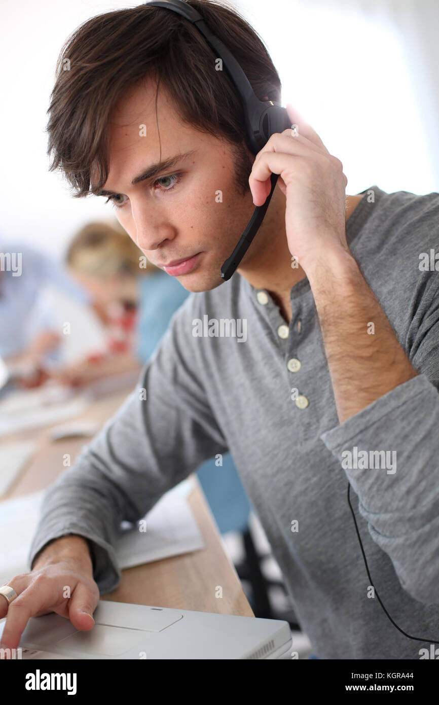 Student with headset on doing English language test Stock Photo - Alamy