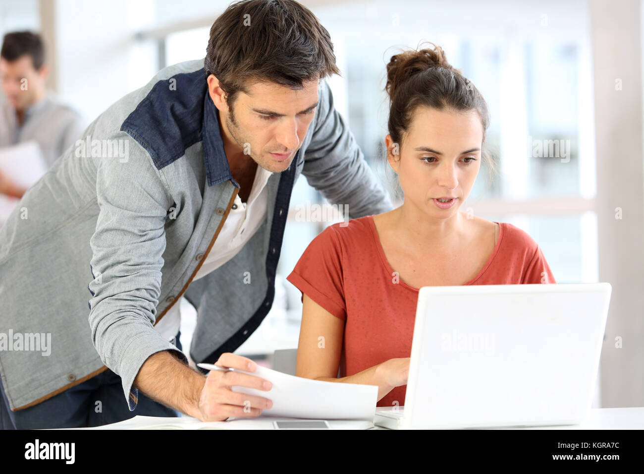 Business team in office working on laptop Stock Photo - Alamy
