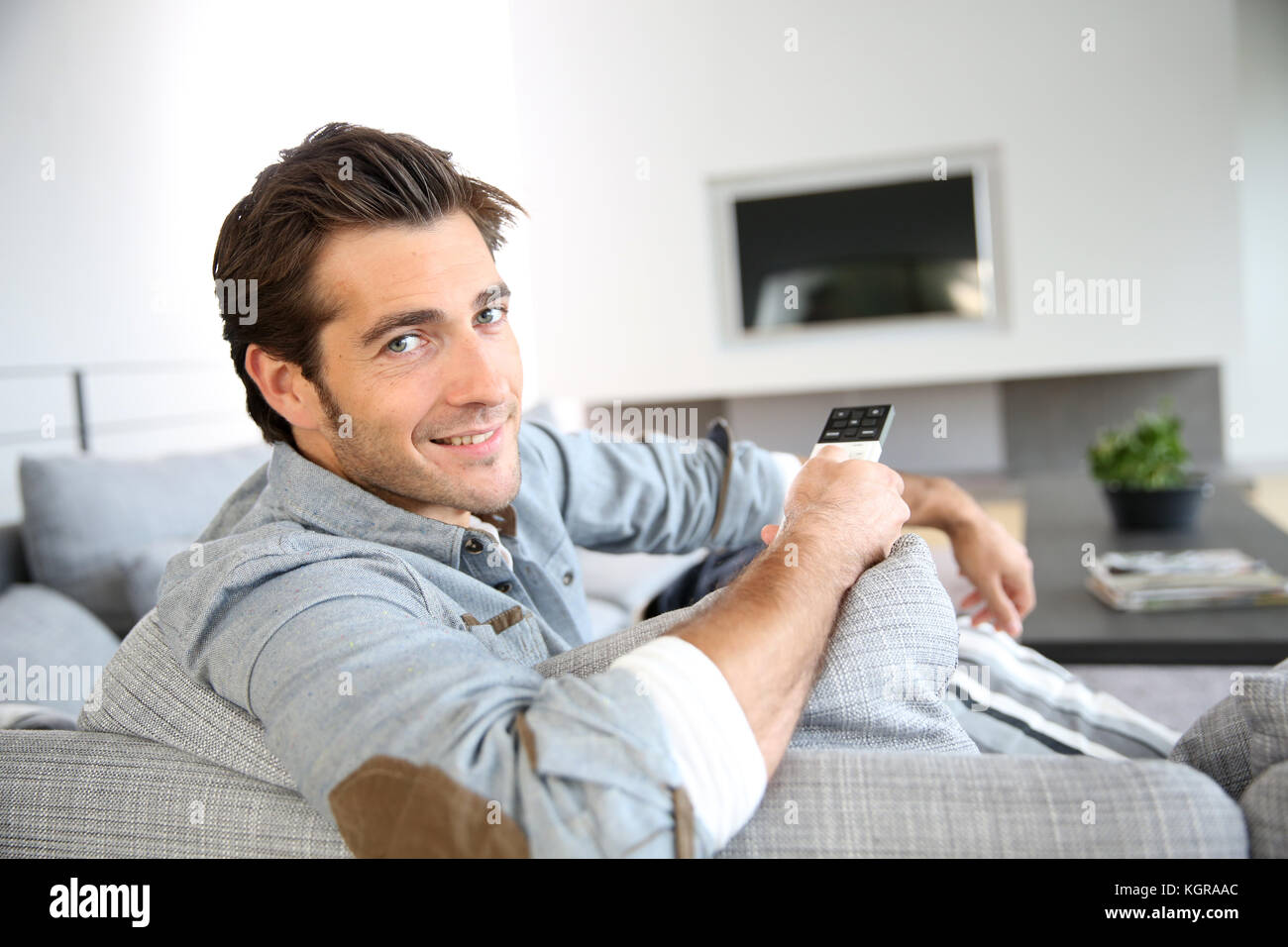 Man at home sitting in front of tv set Stock Photo - Alamy