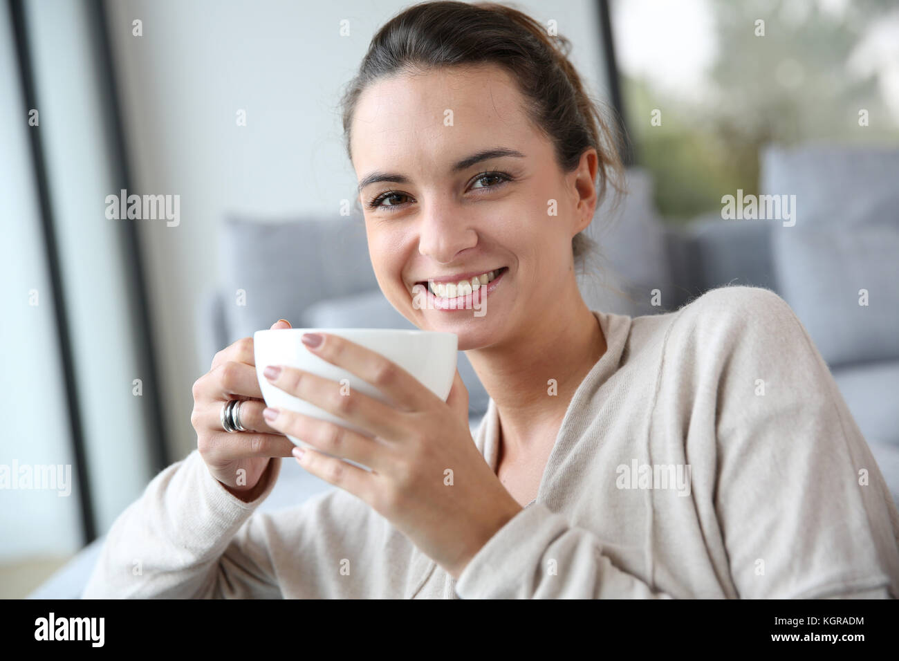 Peaceful woman relaxing at home with cup of tea Stock Photo - Alamy