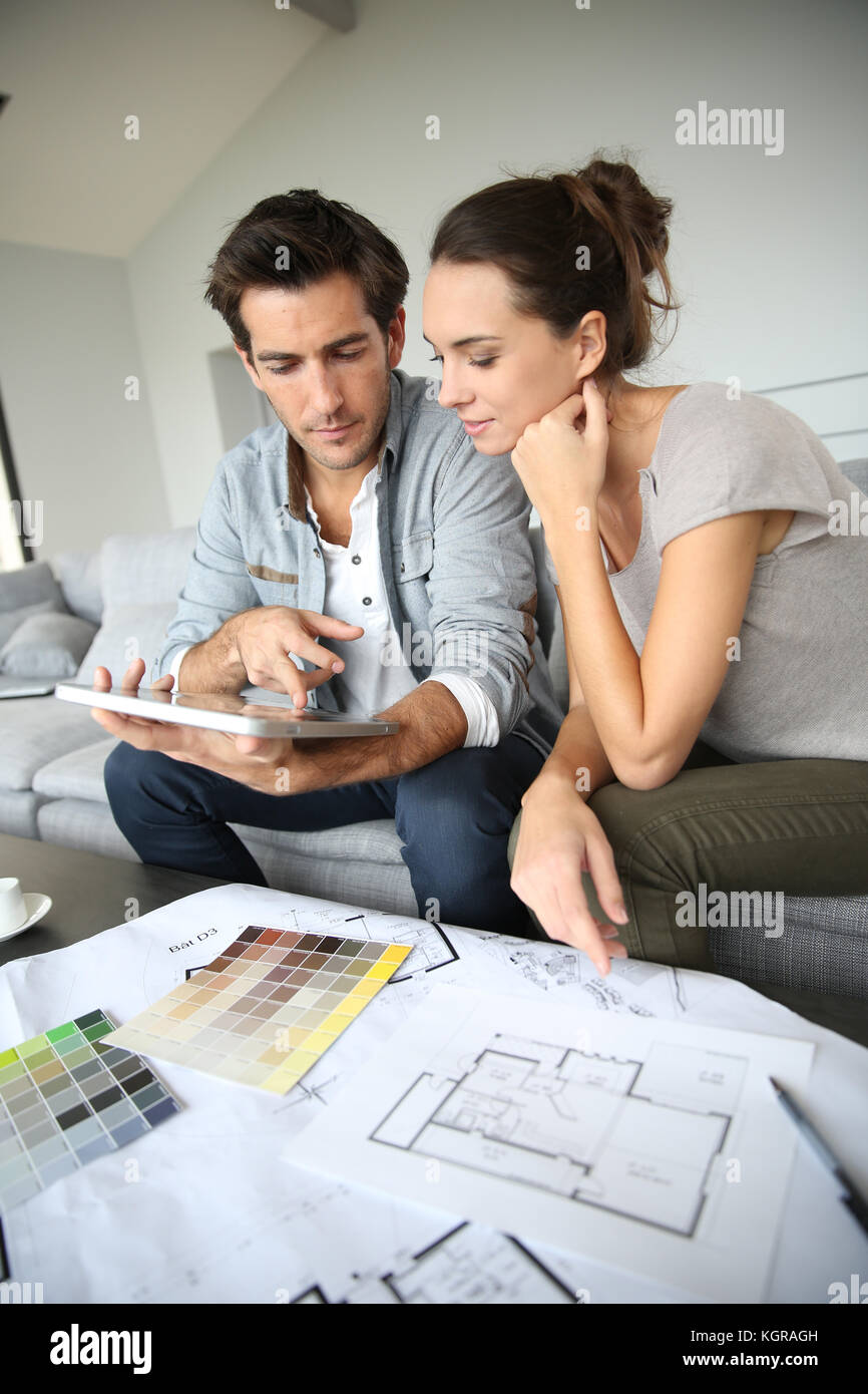 Couple searching ideas to decorate new home Stock Photo - Alamy