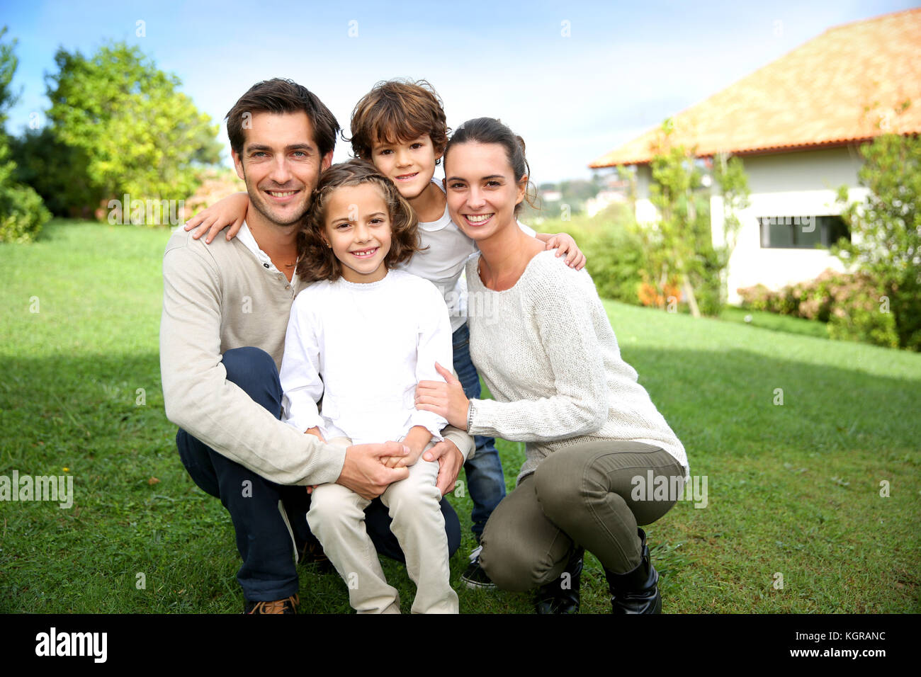 Cute family portrait of 4 people Stock Photo - Alamy