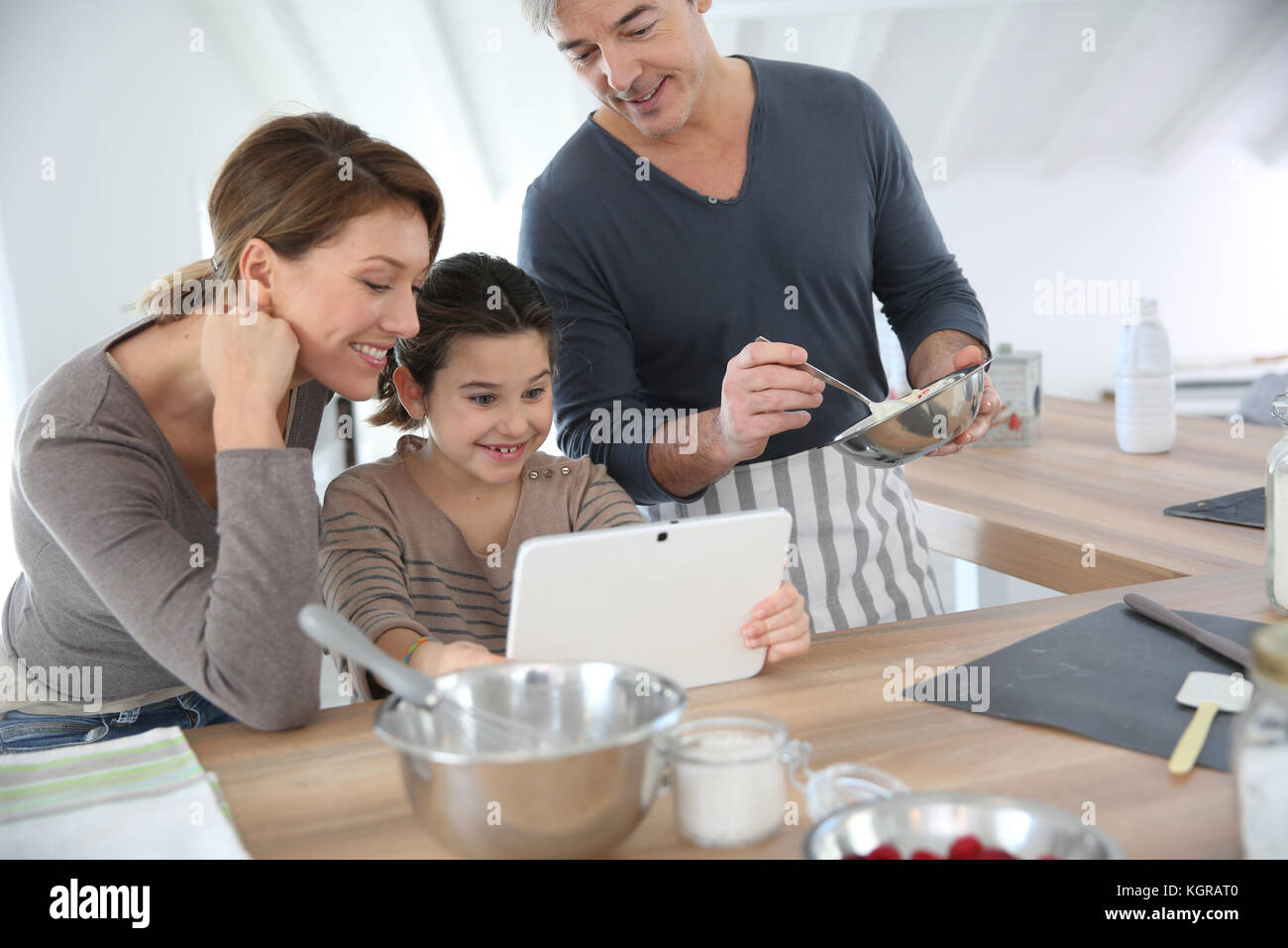 Family in home kitchen preparing pastry Stock Photo - Alamy