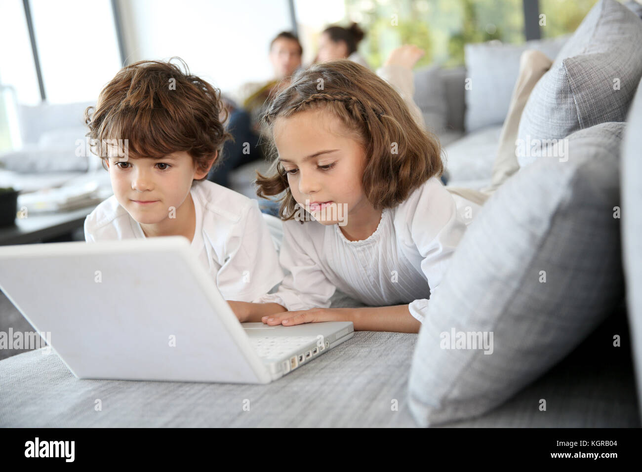 Kids playing with laptop computer at home Stock Photo - Alamy