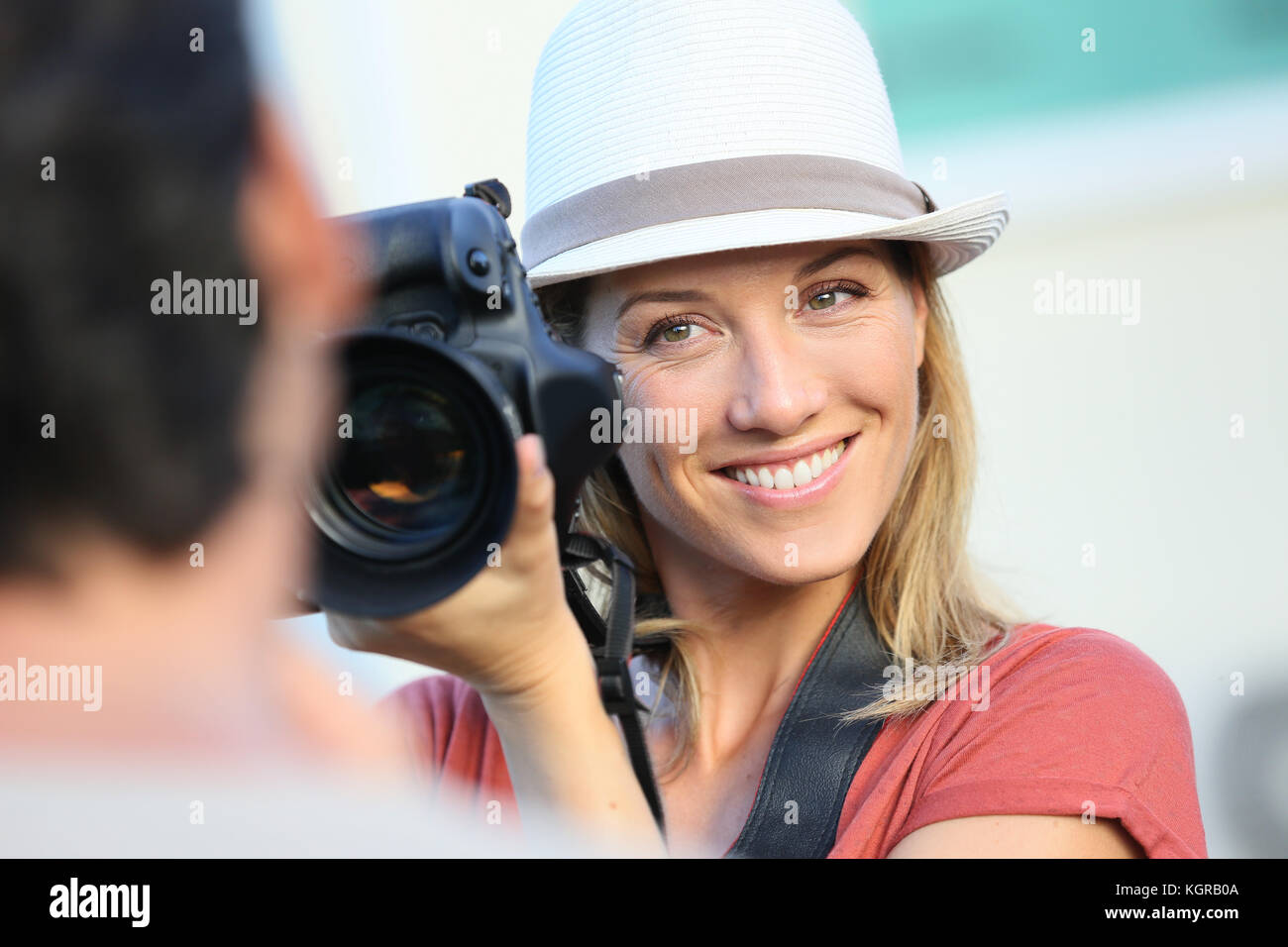 Woman photographer taking picture of model outside Stock Photo - Alamy