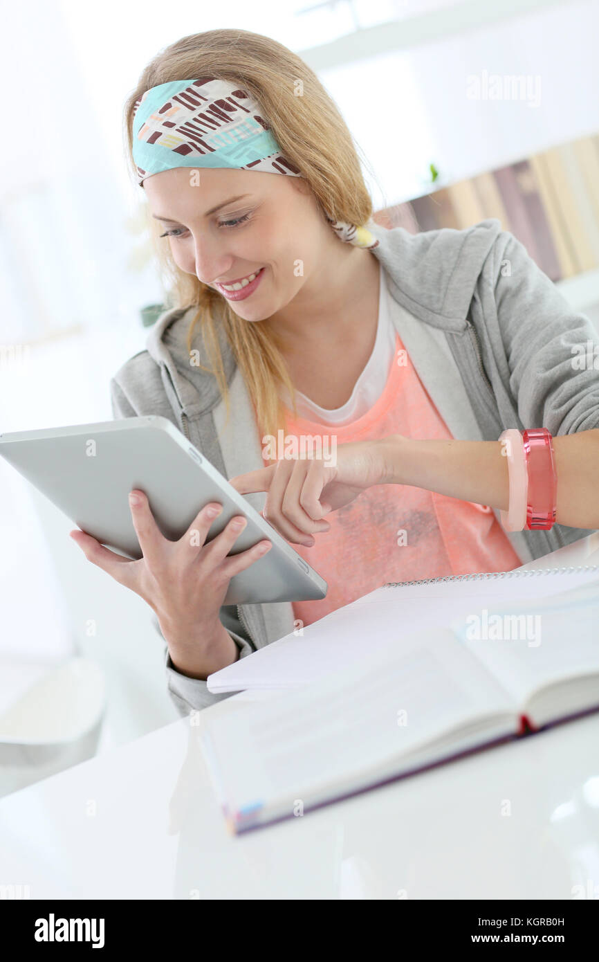 Student girl studying in college library with tablet Stock Photo - Alamy