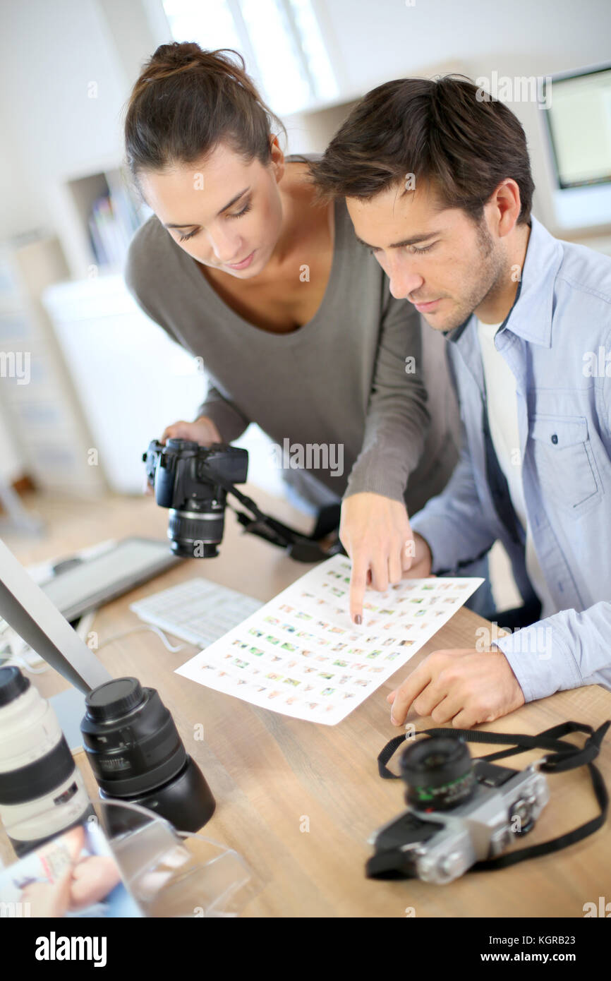 Photo reporters working in office Stock Photo - Alamy