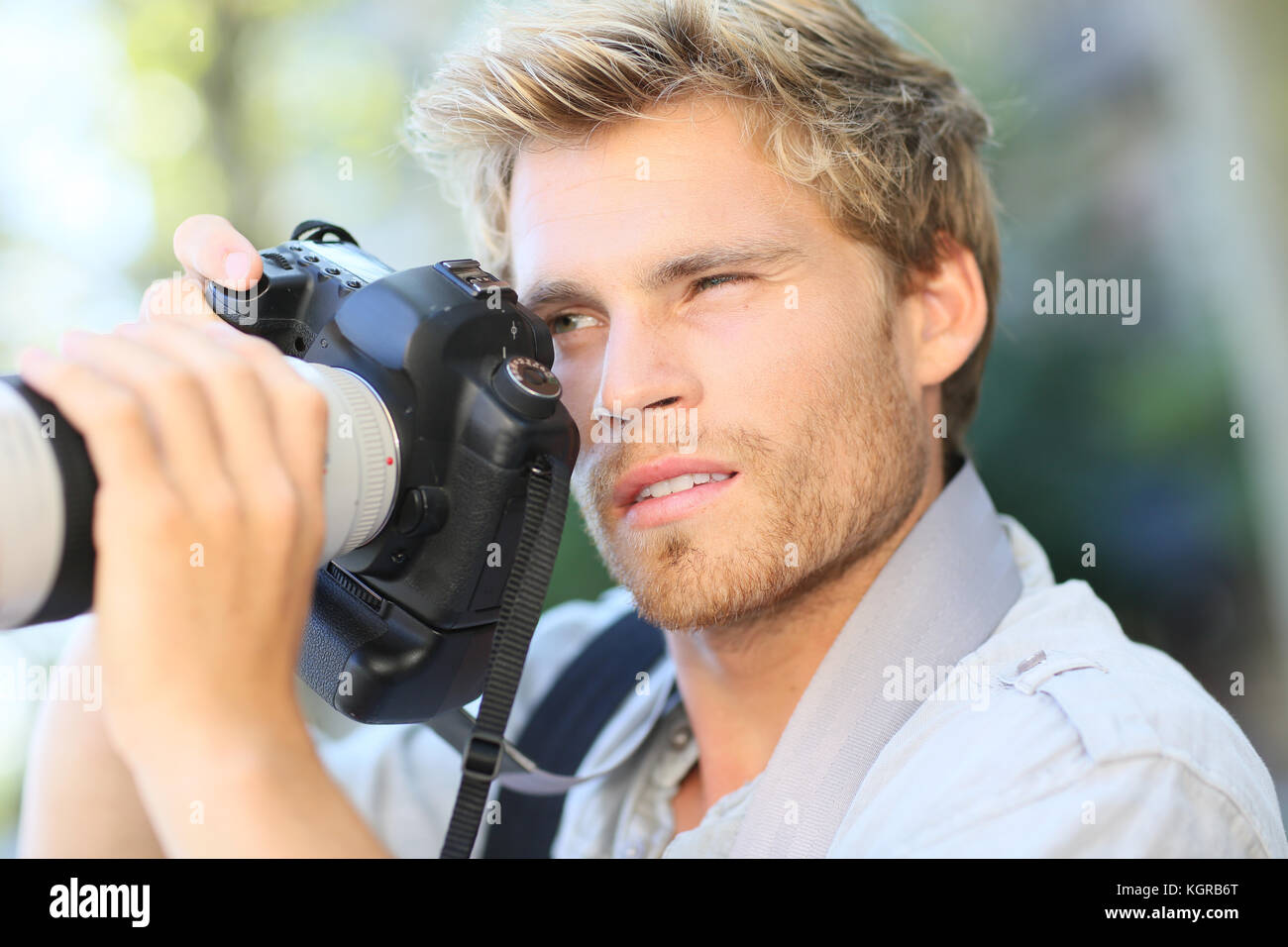 Young photographer shooting with digital camera Stock Photo - Alamy