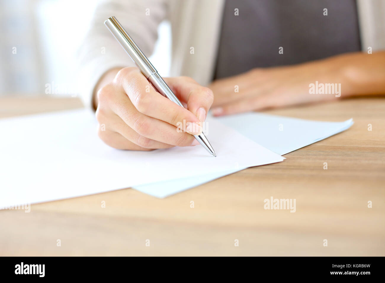 Closeup of woman's hand writing on paper Stock Photo - Alamy