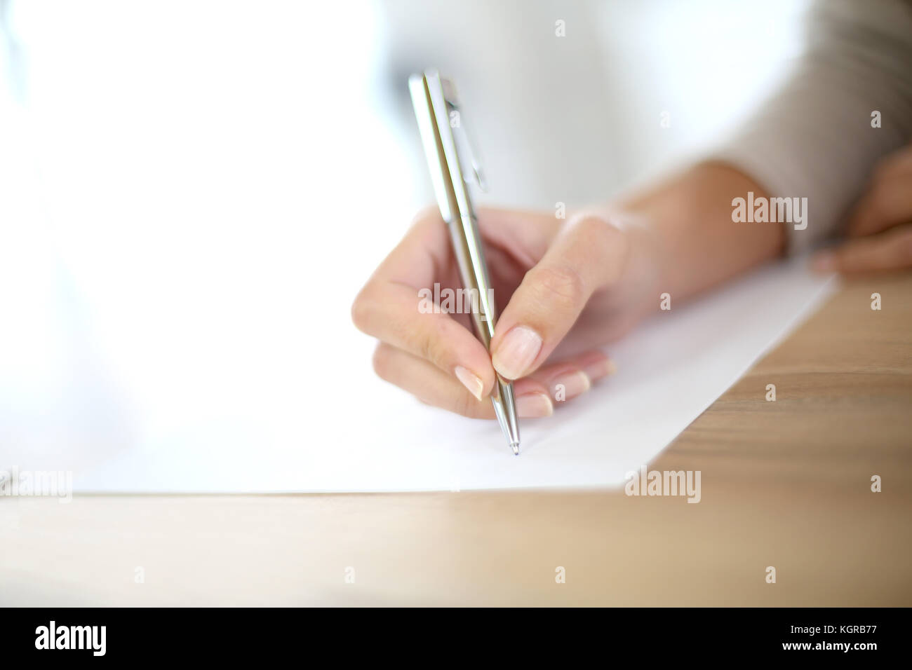Closeup of woman's hand writing on paper Stock Photo - Alamy