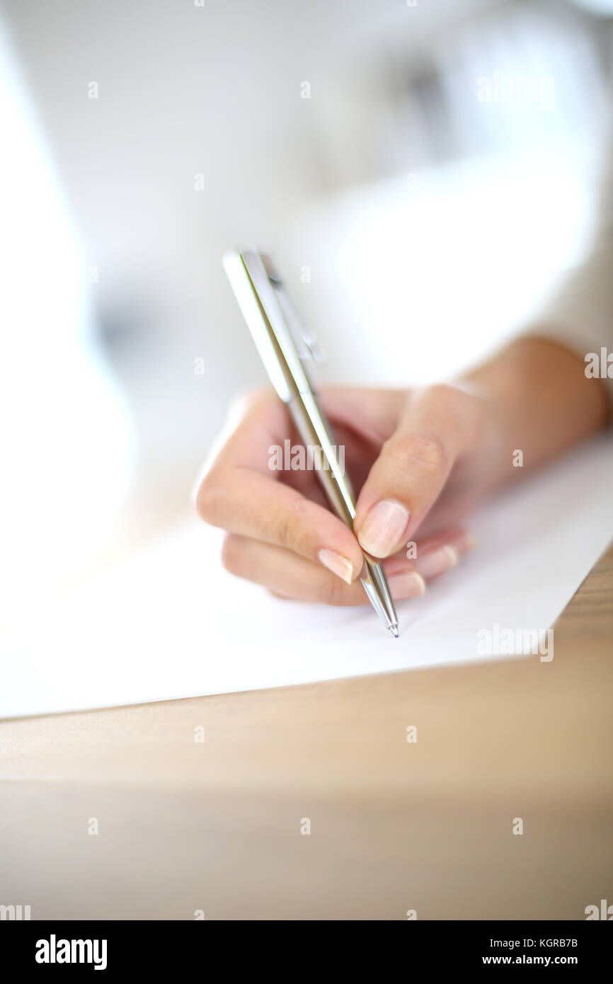 Closeup of woman's hand writing on paper Stock Photo - Alamy