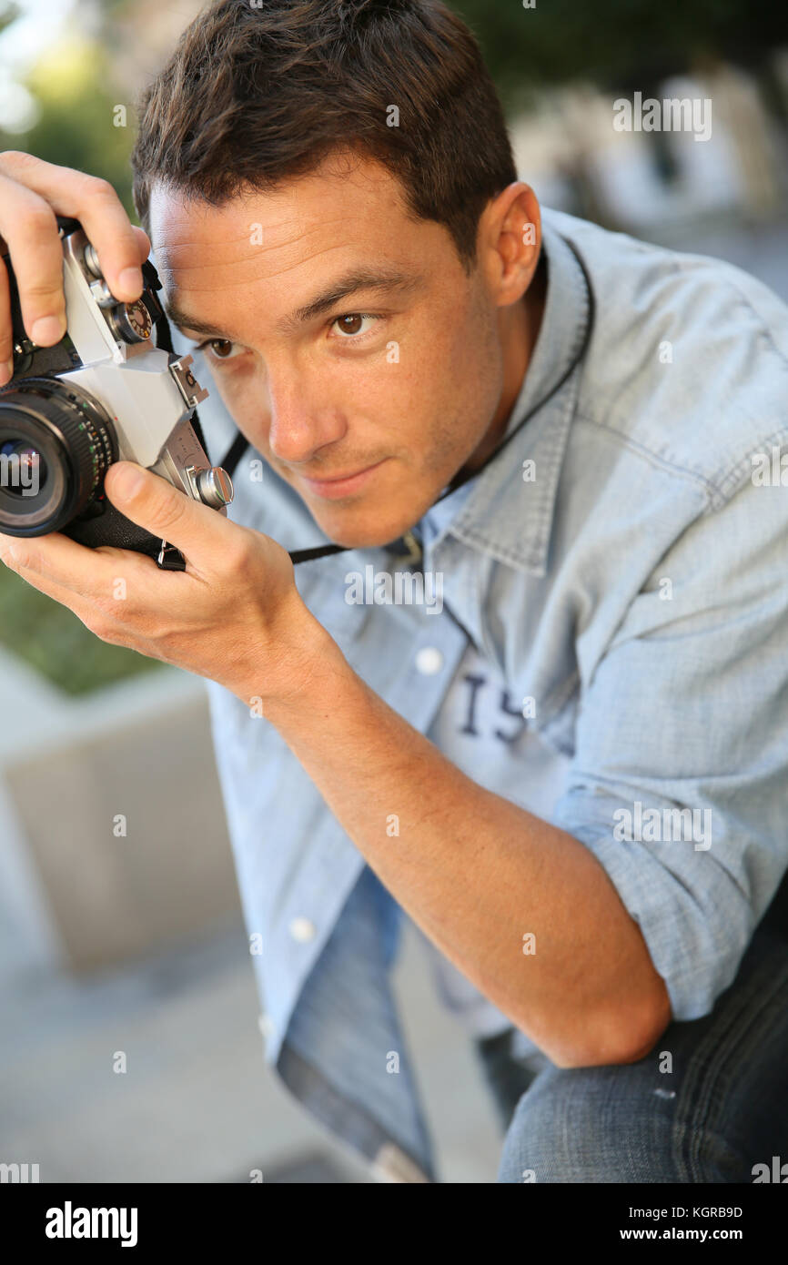 Photographer shooting outside with old camera Stock Photo - Alamy
