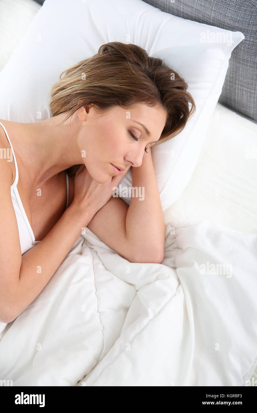 Closeup of woman asleep in bed Stock Photo - Alamy