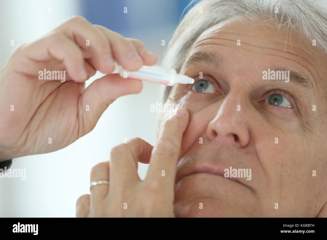 Senior man injecting eye serum Stock Photo - Alamy