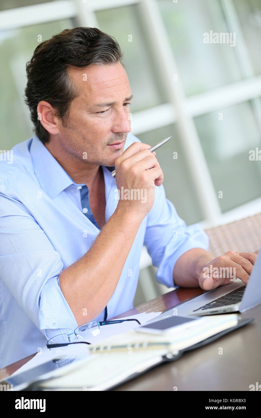 Man working from home on laptop computer Stock Photo - Alamy
