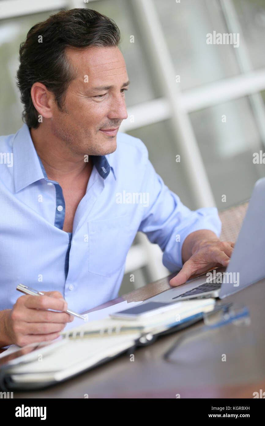 Man working from home on laptop computer Stock Photo - Alamy