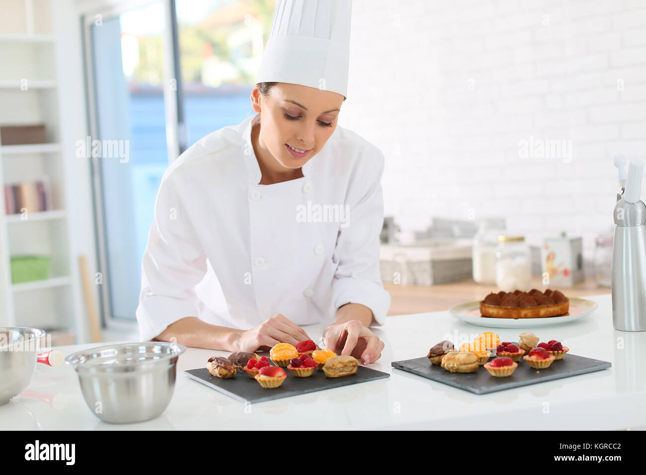 Pastry-cook preparing plate of cake bites Stock Photo - Alamy