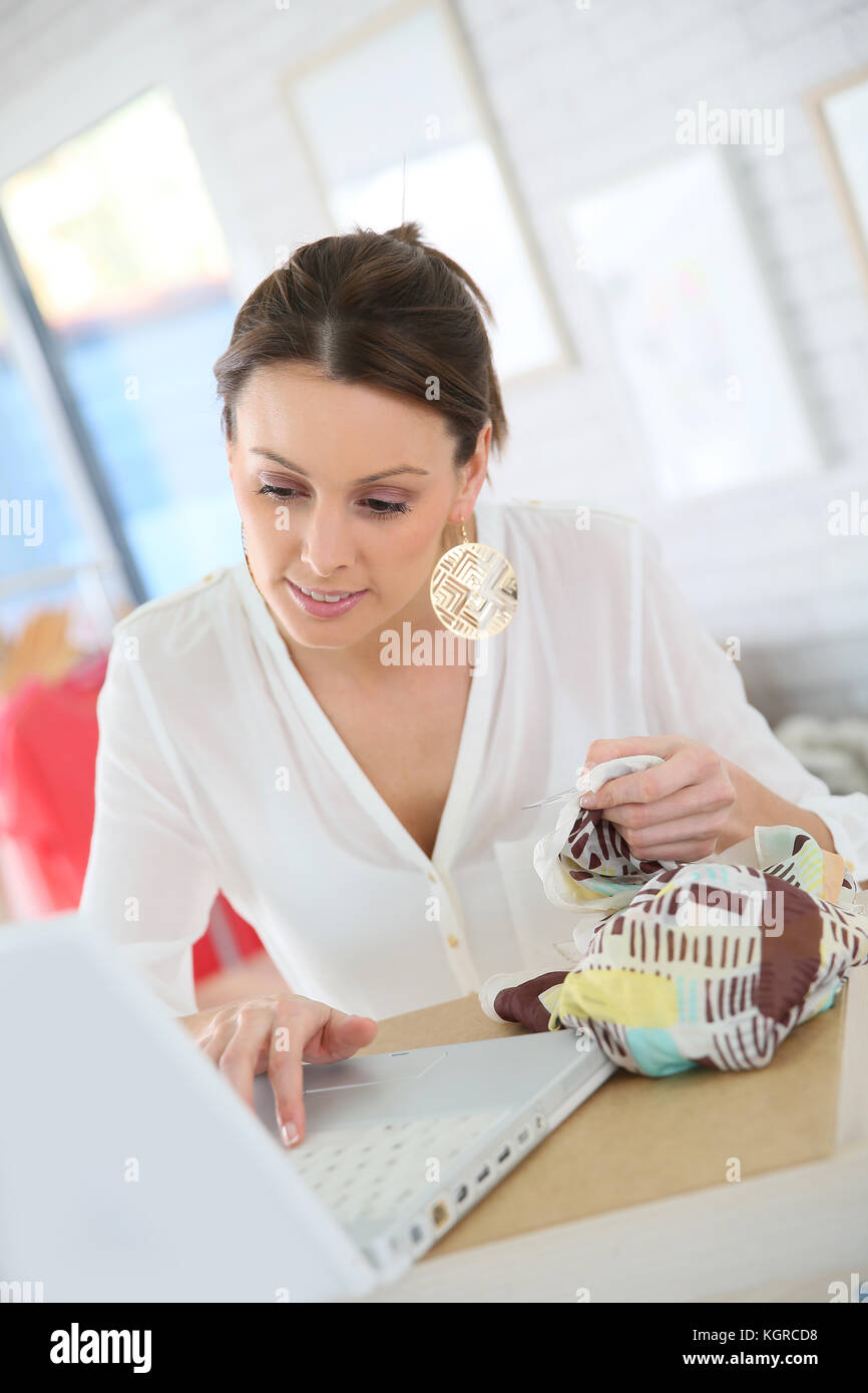 Beautiful shopgirl working in clothing store Stock Photo - Alamy