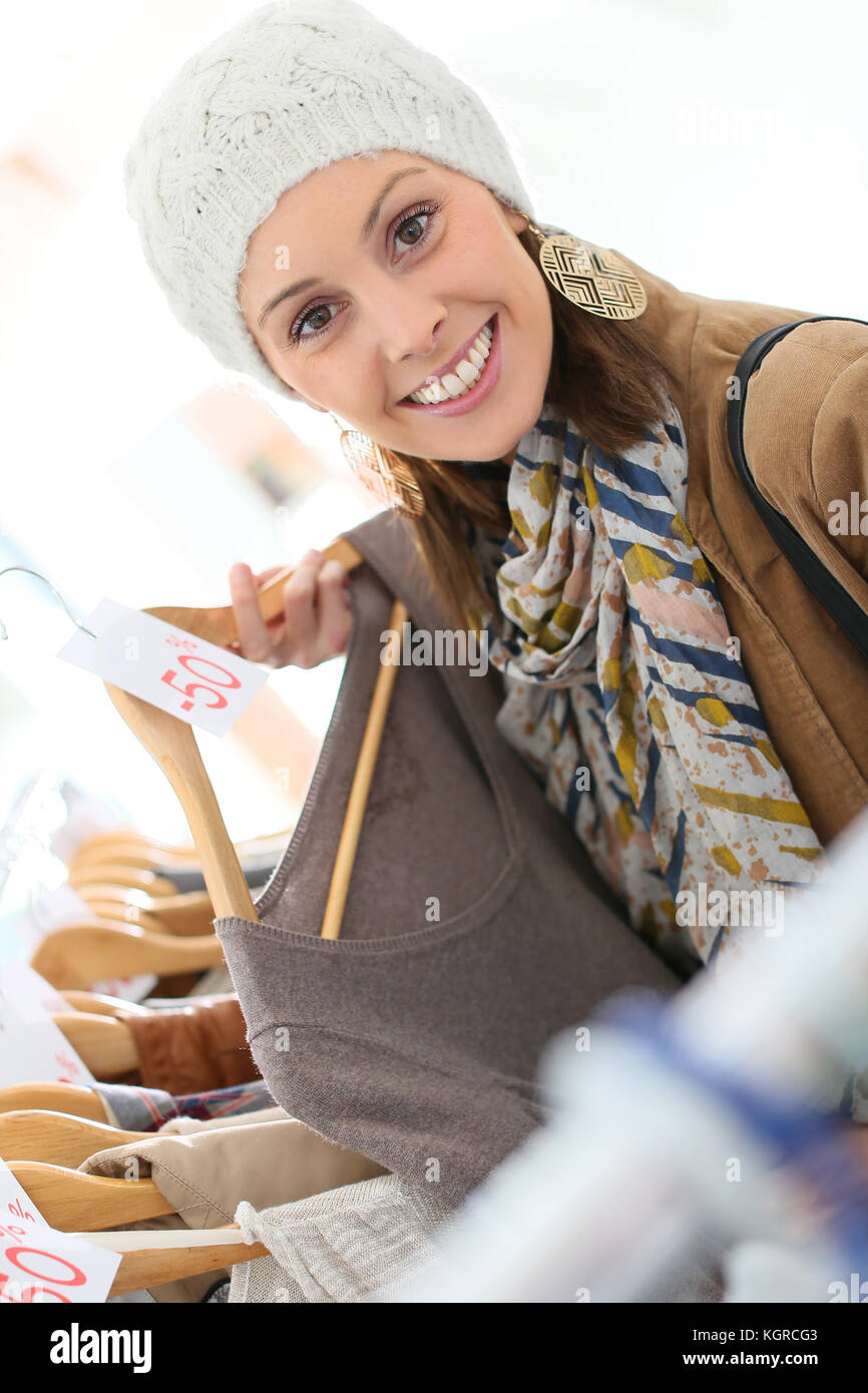 Beautiful woman in store choosing clothes on sale Stock Photo - Alamy