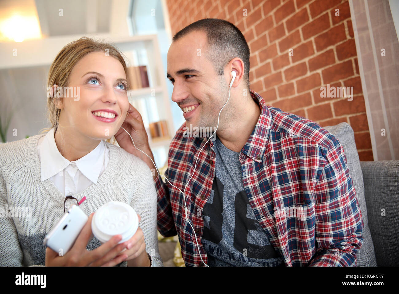 Friends having fun listening to music on smartphone Stock Photo - Alamy