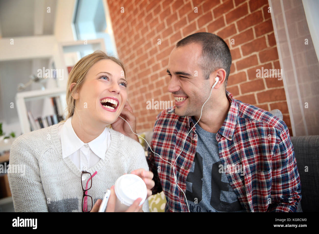 Friends having fun listening to music on smartphone Stock Photo - Alamy