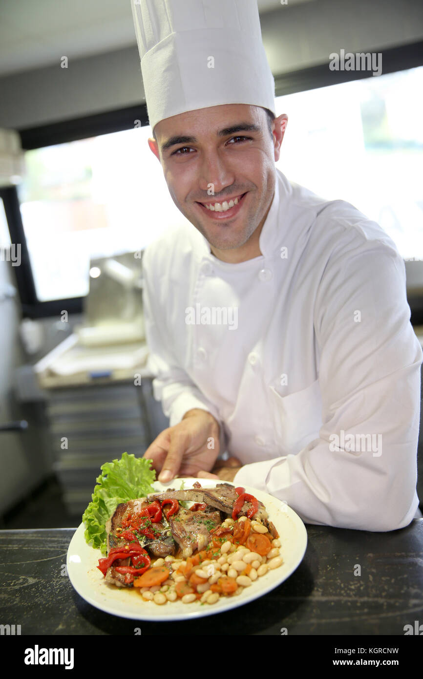 Portrait of young chef in restaurant Stock Photo - Alamy