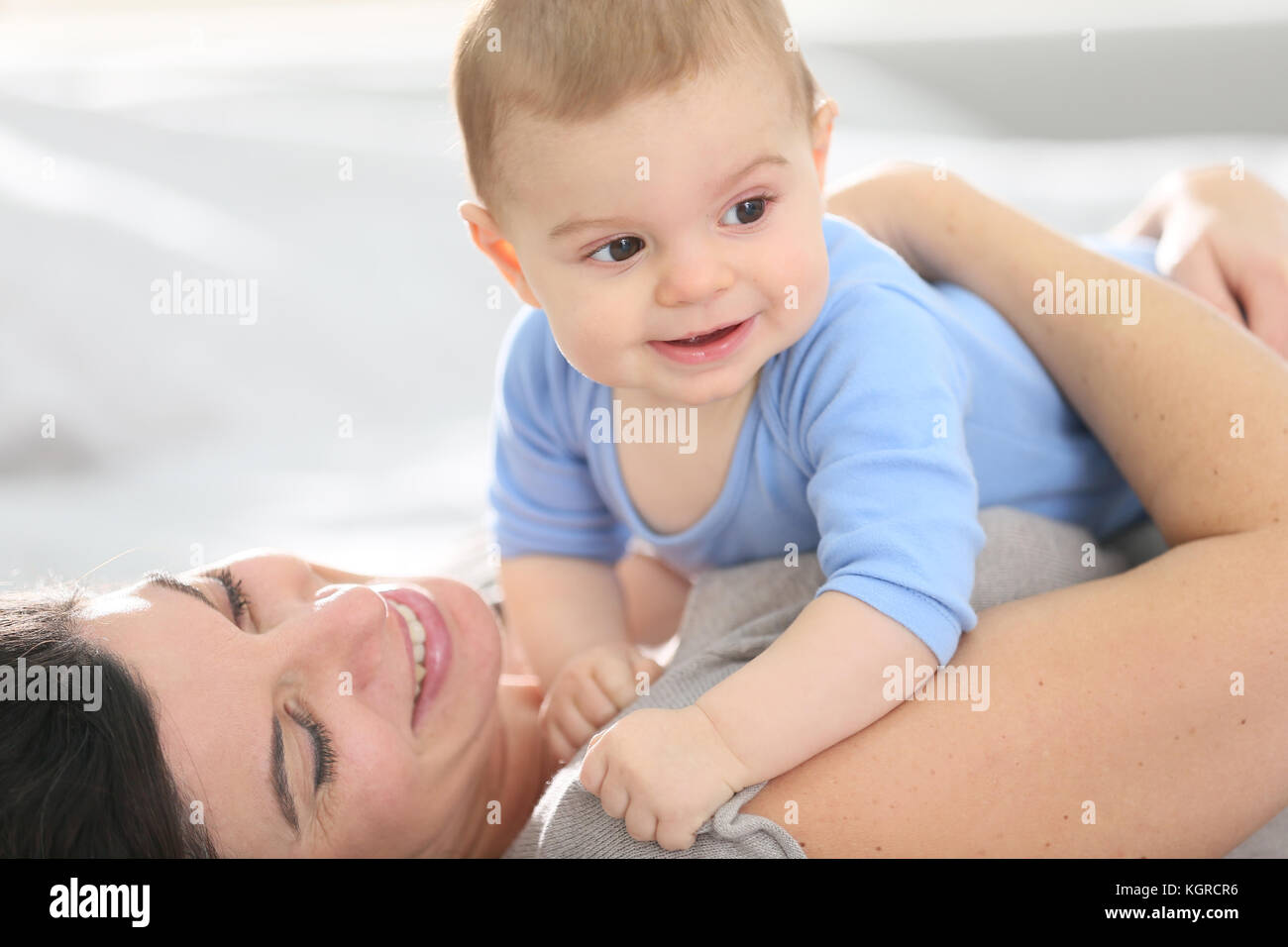 Portrait of mother cuddling baby boy Stock Photo - Alamy