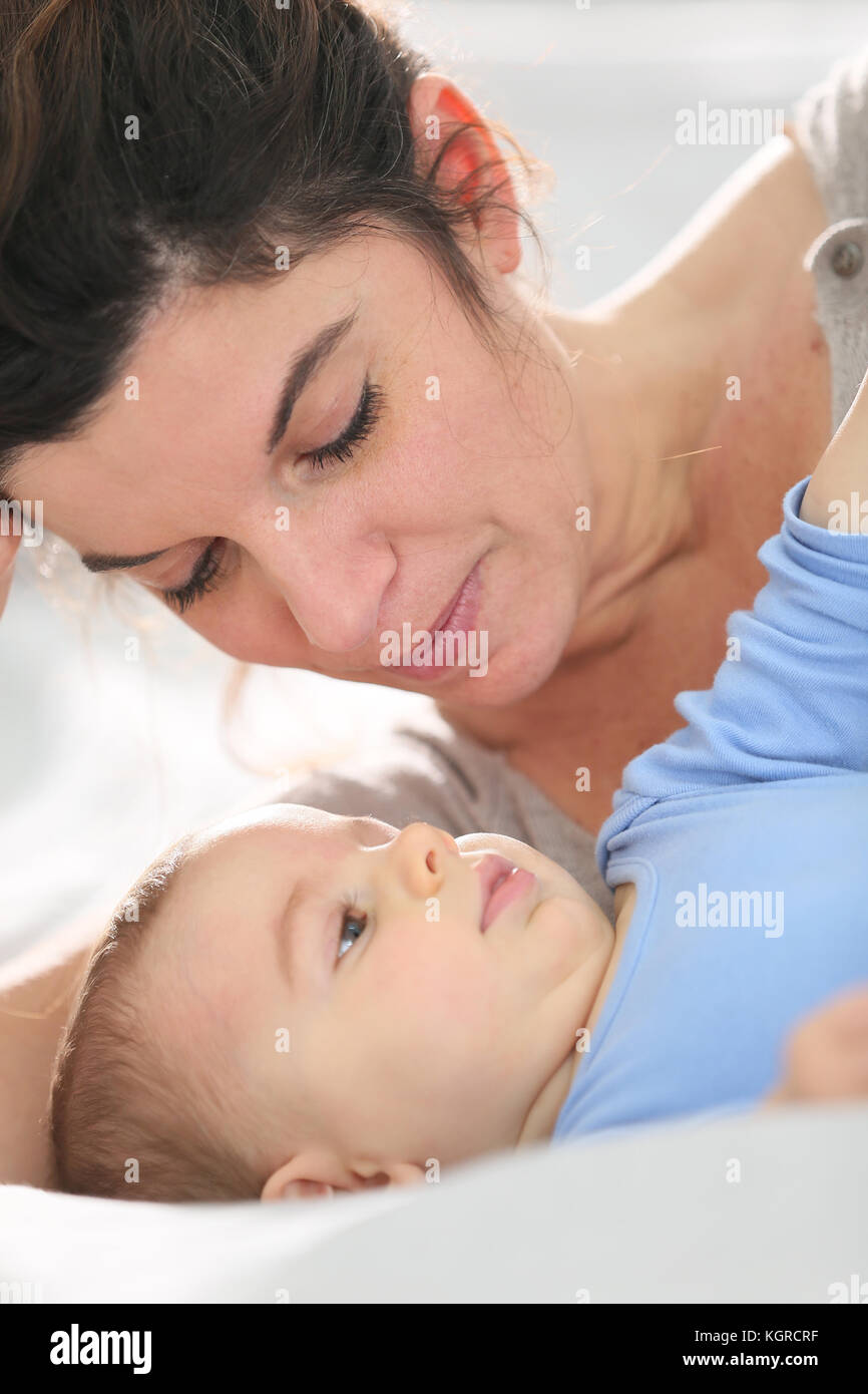 Portrait of mother cuddling baby boy Stock Photo - Alamy