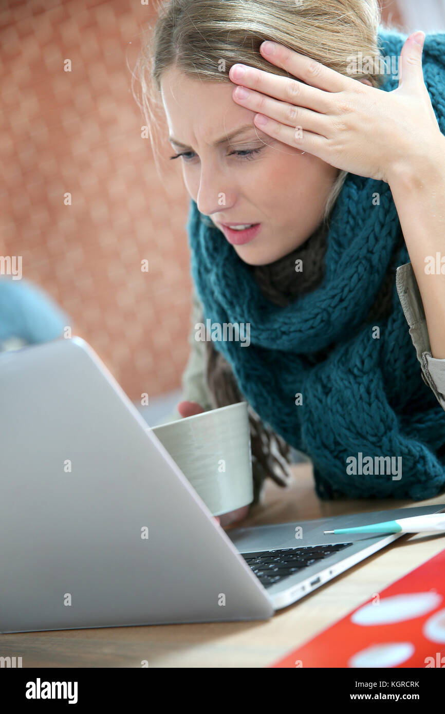 Young woman working at home and being sick Stock Photo - Alamy