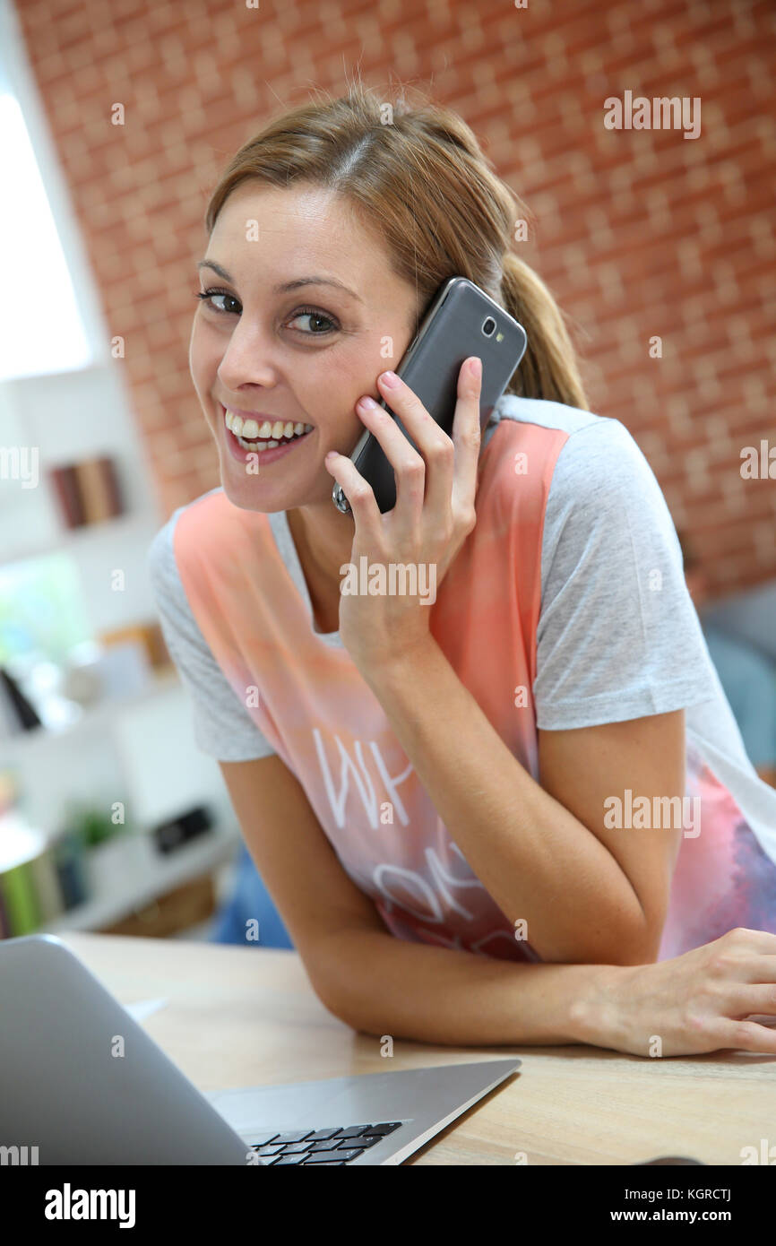 Smiling girl at home talking on mobile phone Stock Photo - Alamy
