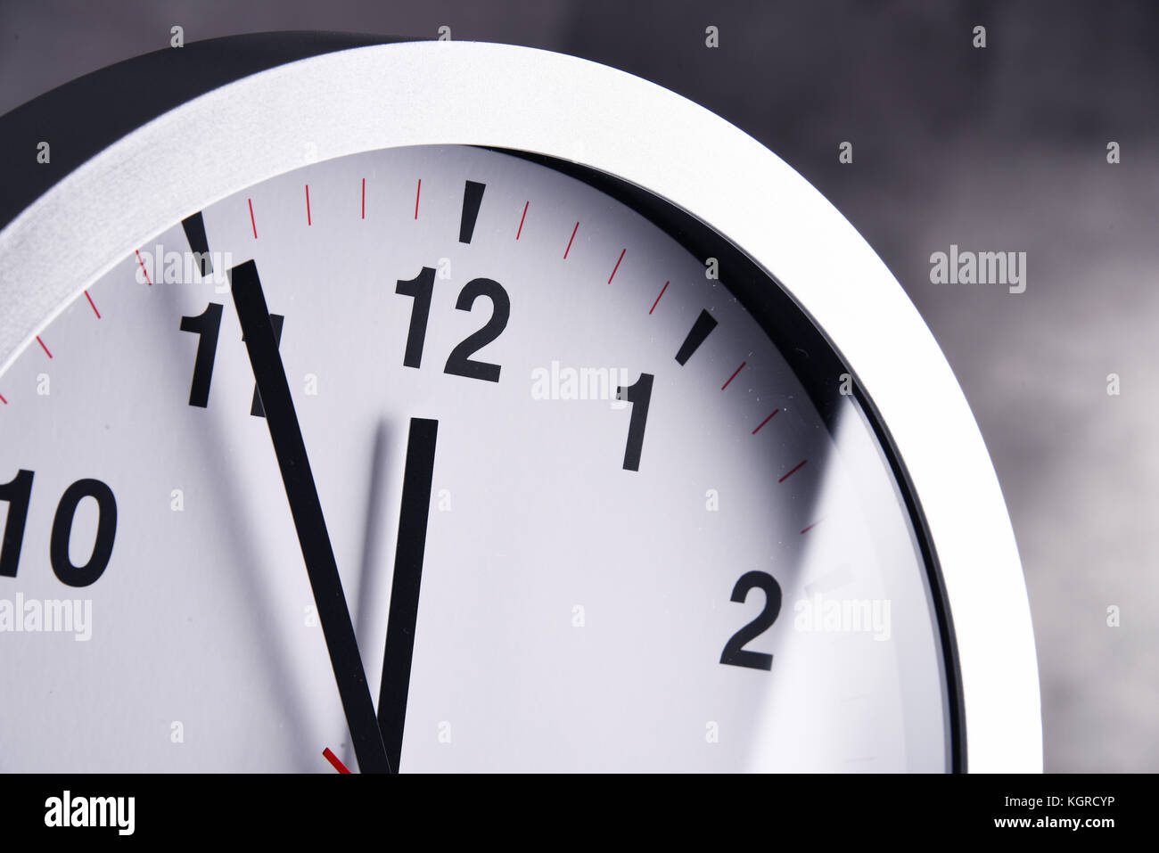 Wall clock showing five to twelve Stock Photo - Alamy