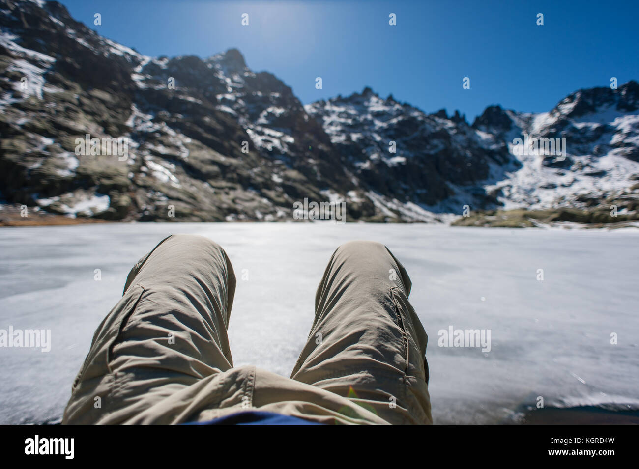 Resting legs by frozen lake Stock Photo - Alamy