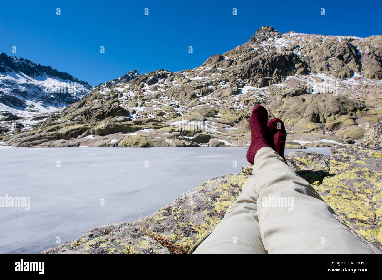Resting legs by frozen lake Stock Photo - Alamy