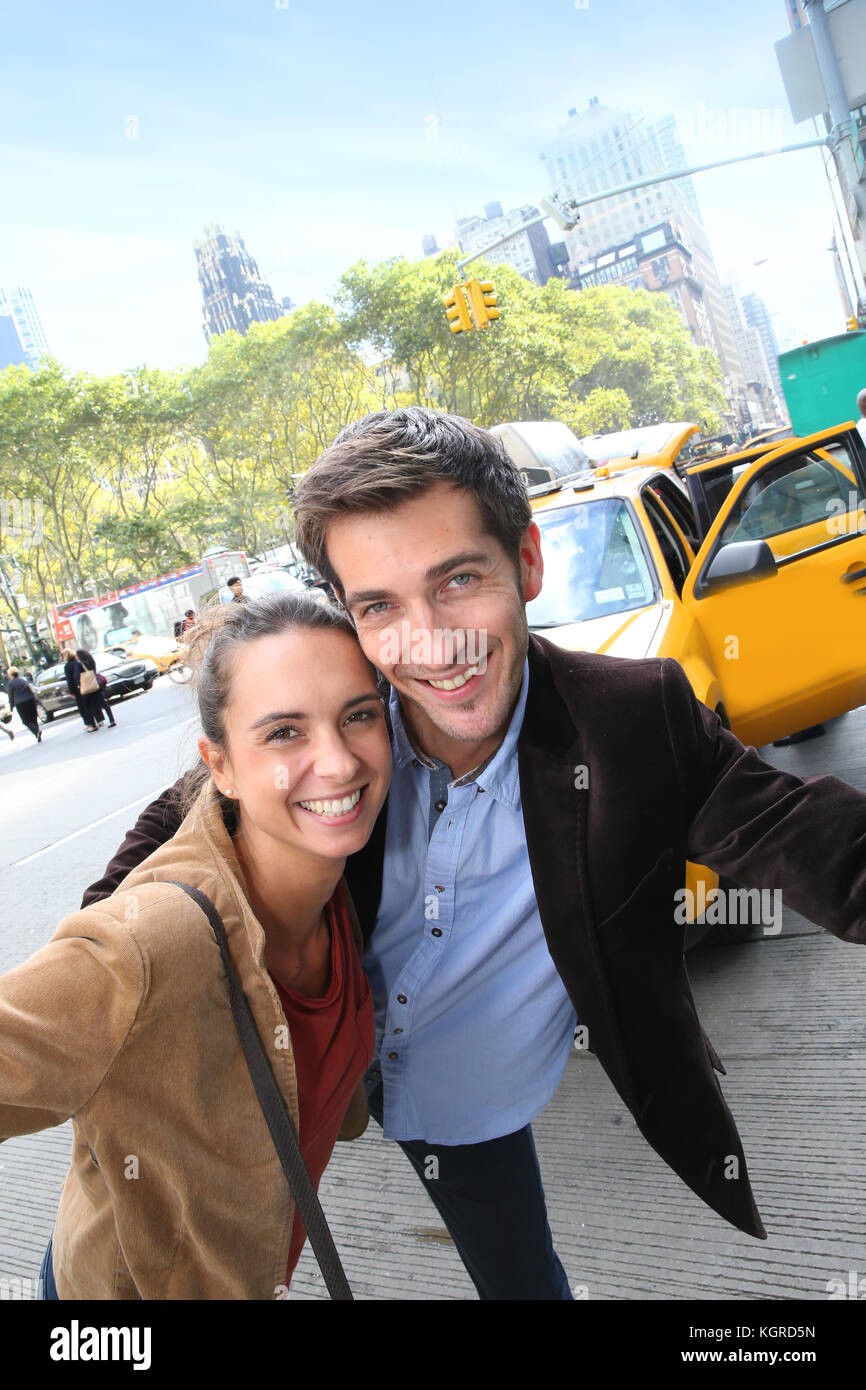 Couple having fun in Manhattan, taxi cab in background Stock Photo - Alamy