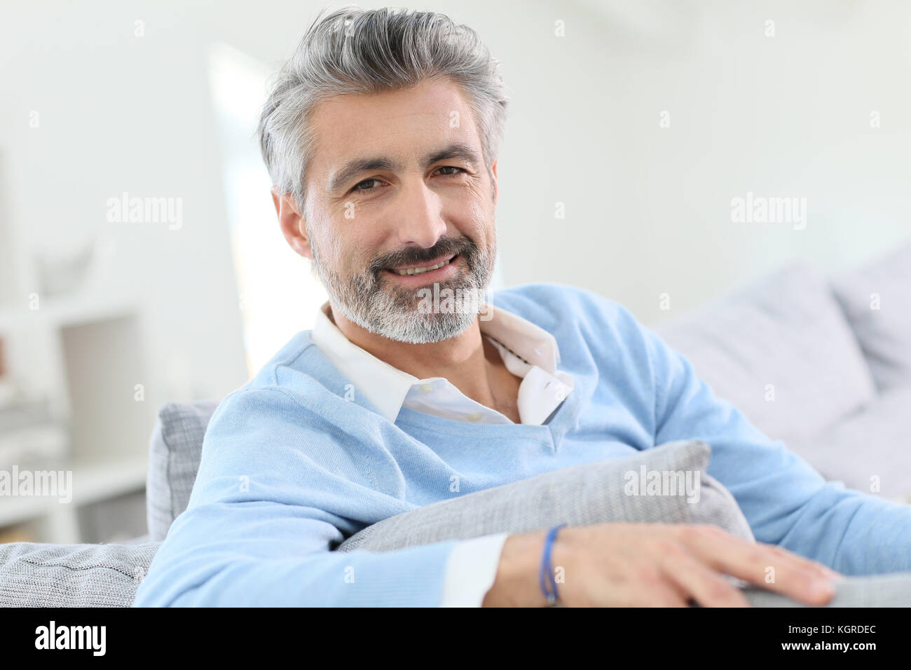 45-year-old man relaxing in sofa at home Stock Photo - Alamy