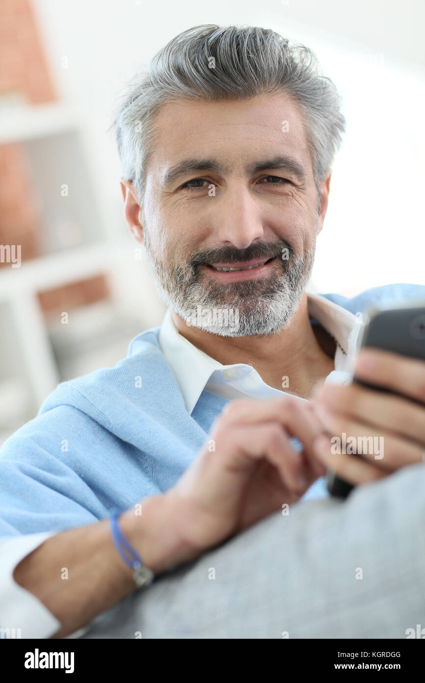 Mature man sending message with smartphone Stock Photo - Alamy
