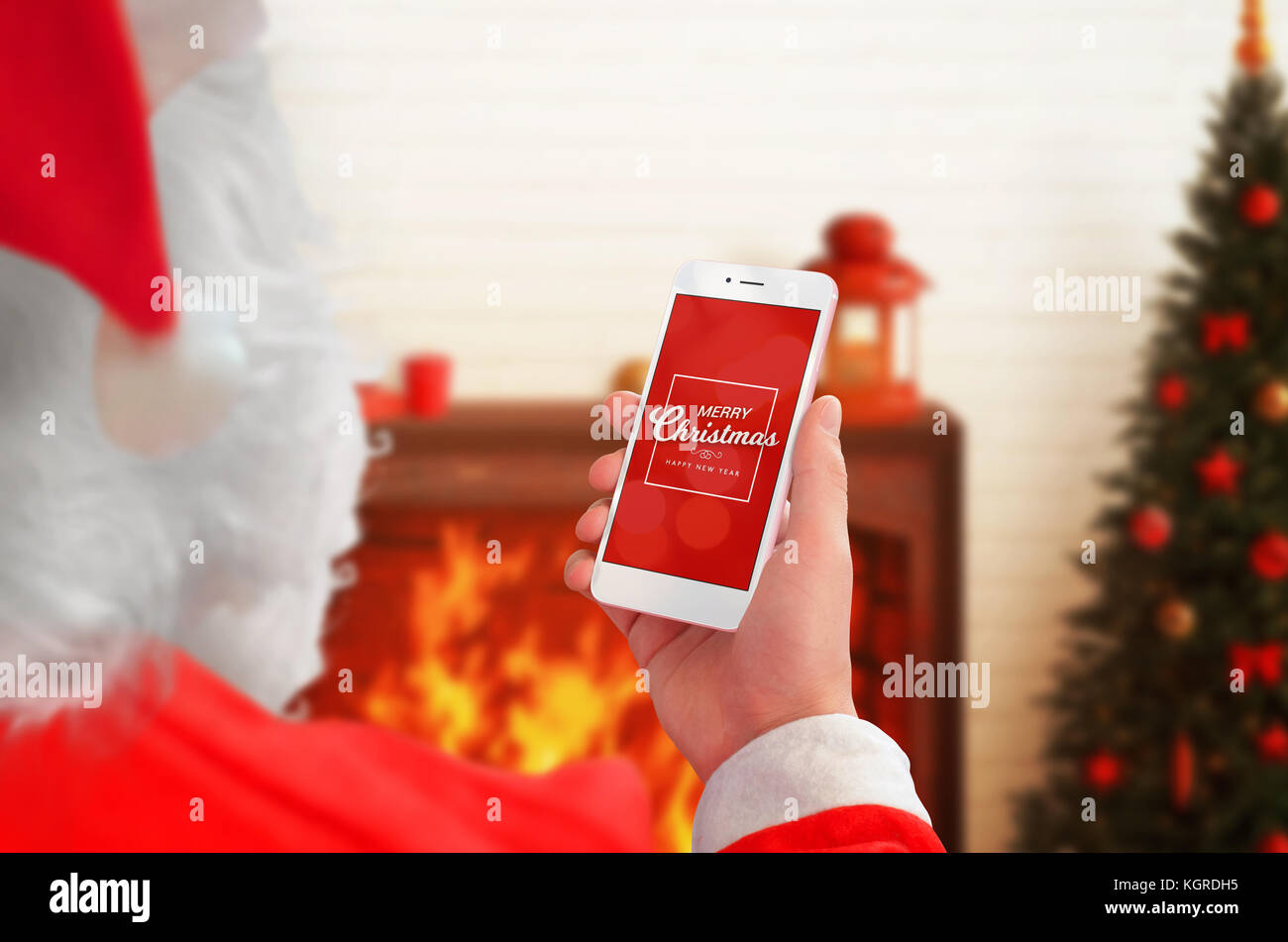 Santa Claus holding mobile phone with Christmas greeting on display ...