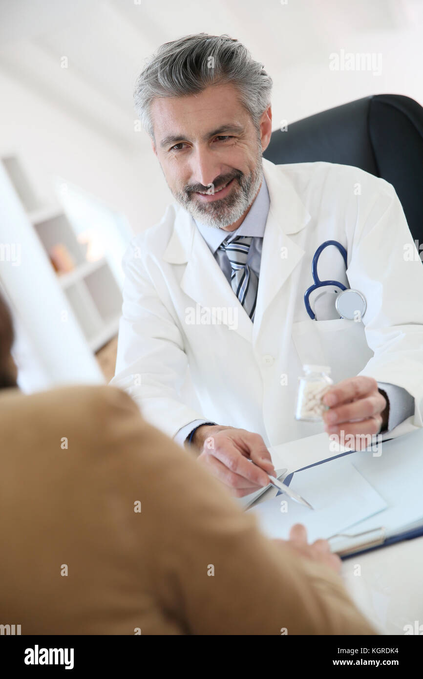 Doctor giving prescription to patient Stock Photo - Alamy