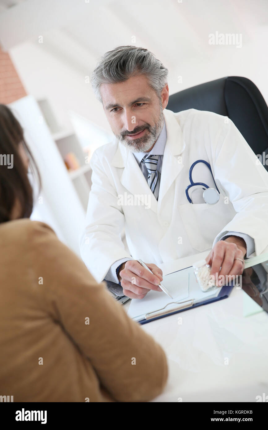 Doctor giving prescription to patient Stock Photo - Alamy