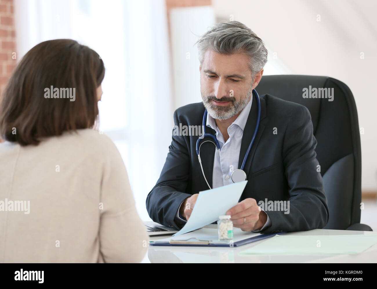 Doctor giving prescription to patient Stock Photo - Alamy