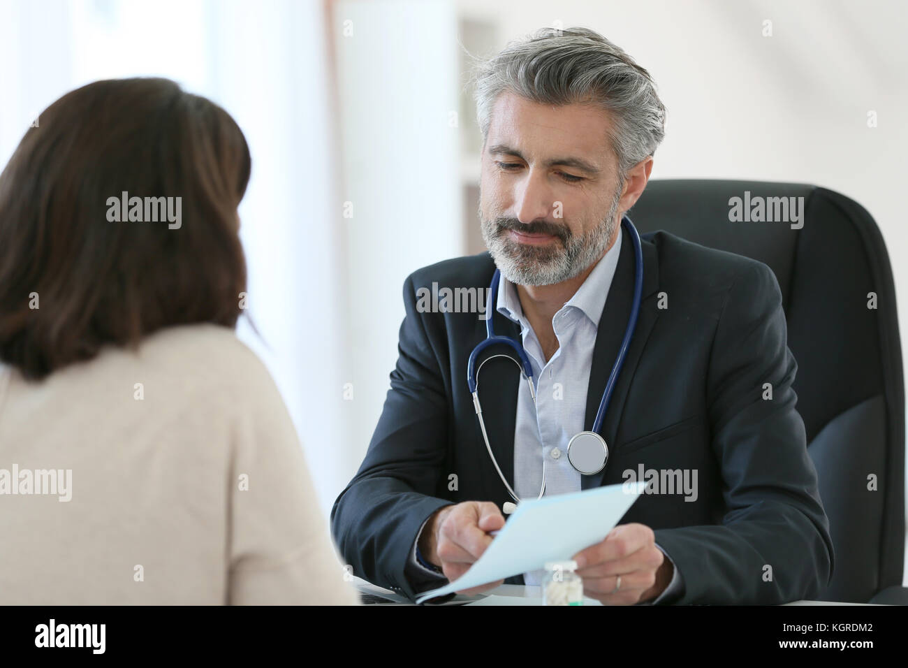 Doctor giving prescription to patient Stock Photo - Alamy
